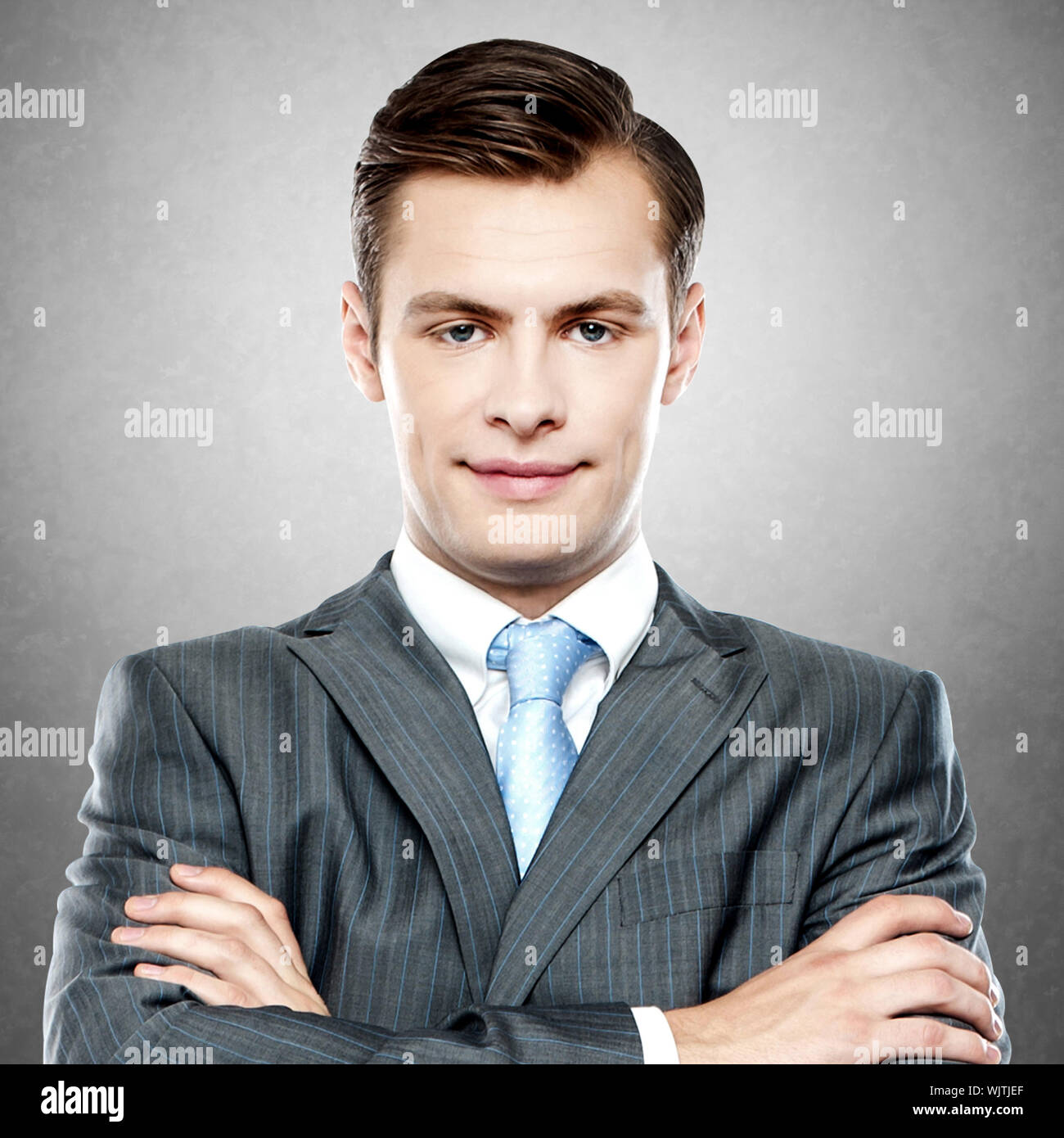 Corporate guy posing with arms crossed Stock Photo - Alamy