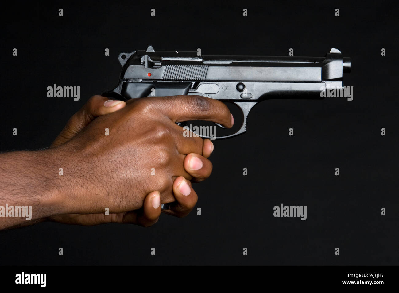 Gun in Hands Stock Photo - Alamy