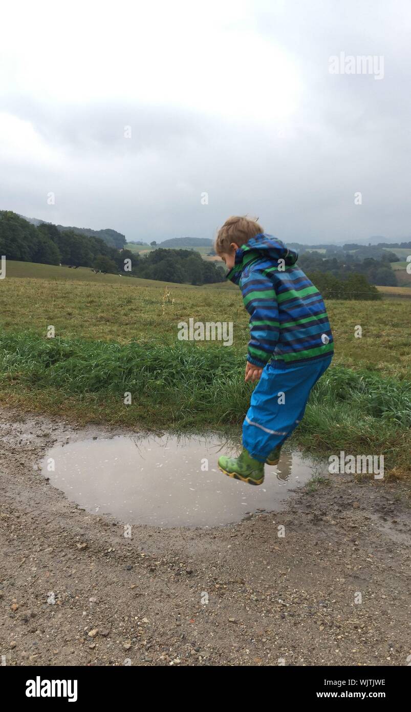 Jumping over puddle hi-res stock photography and images - Alamy