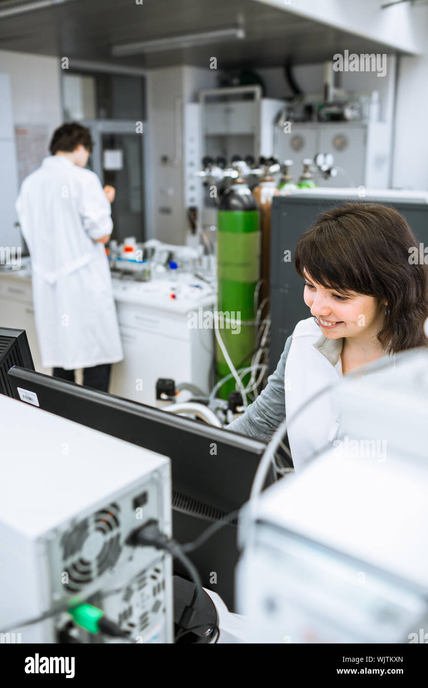 Portrait of a female researcher doing research in a lab (shallow DOF ...