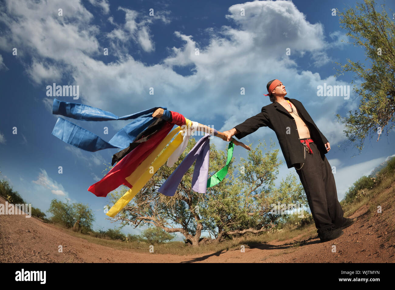Native American man with colorful flags representing seven directions ...