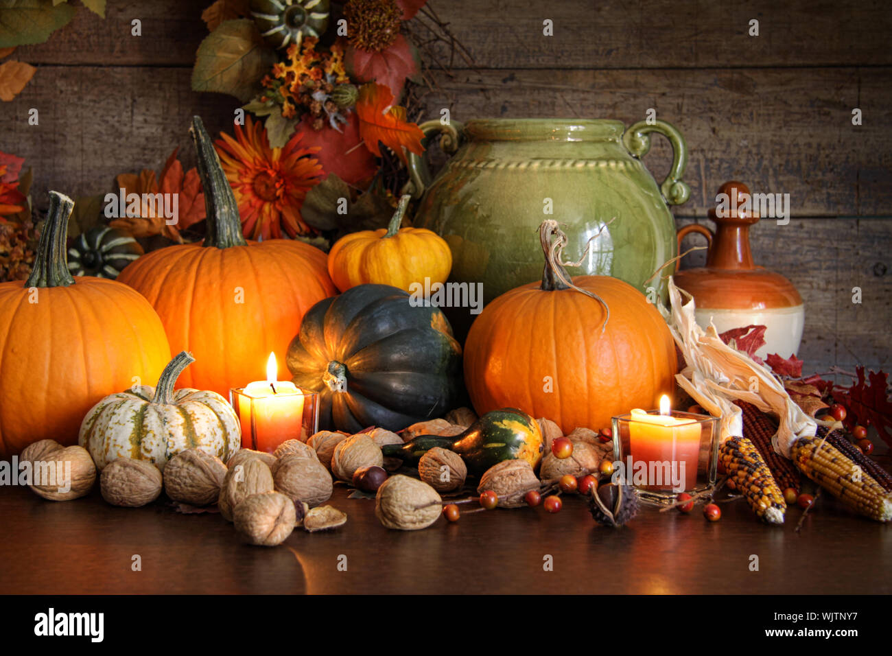 Festive autumn variety of gourds and pumpkins with wood background ...