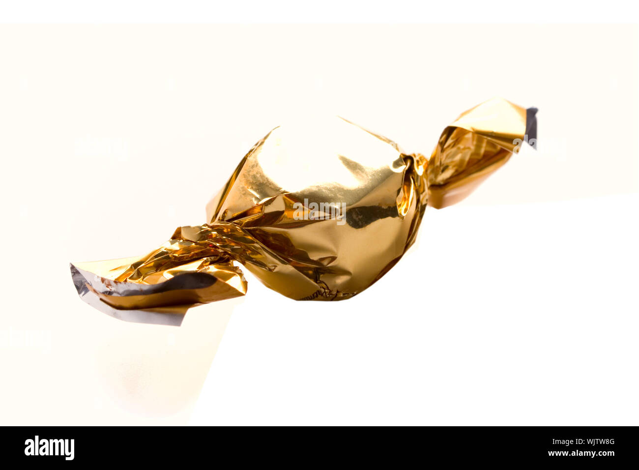 gold sweet closeup on white background Stock Photo - Alamy