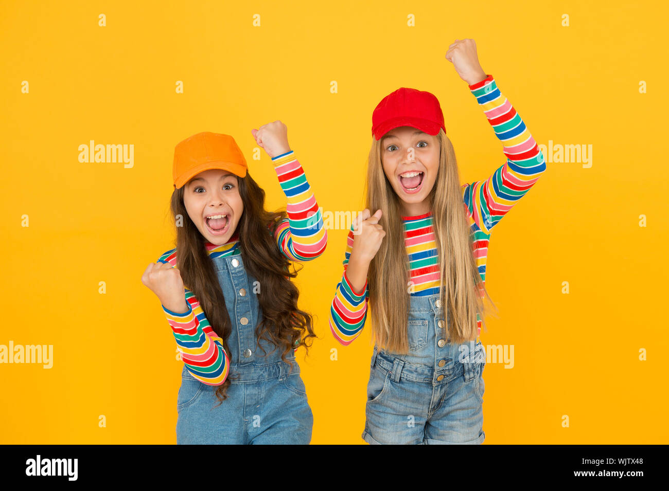 Being happy and victorious. Little girls making victory gestures on ...