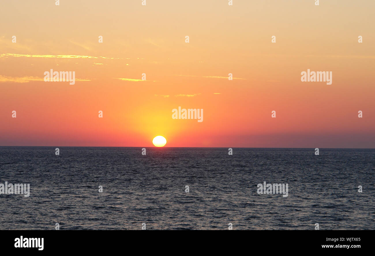 sundown sun on sea seaside Stock Photo - Alamy