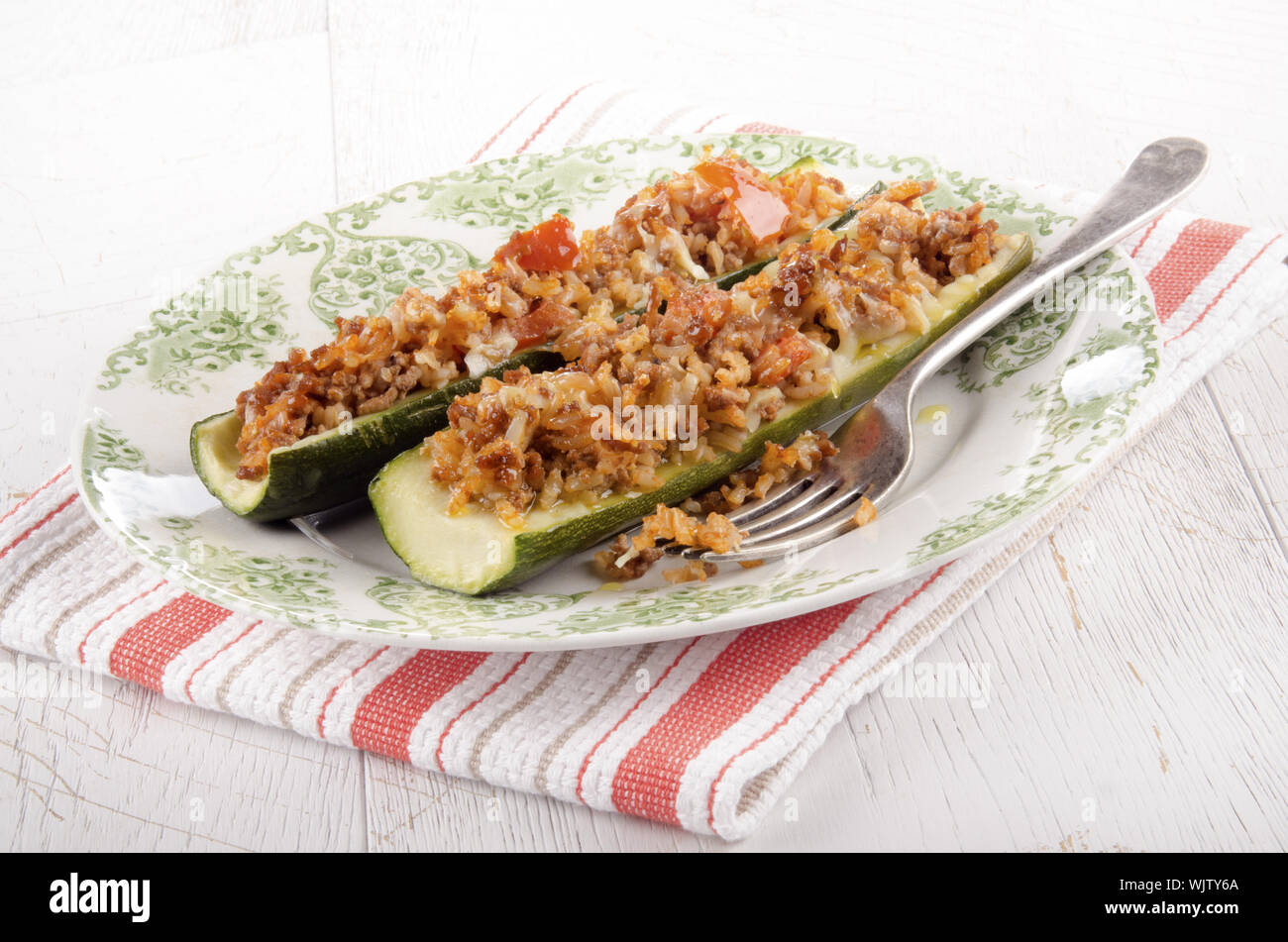 stuffed zucchini with rice and minced meat filling on a plate Stock ...
