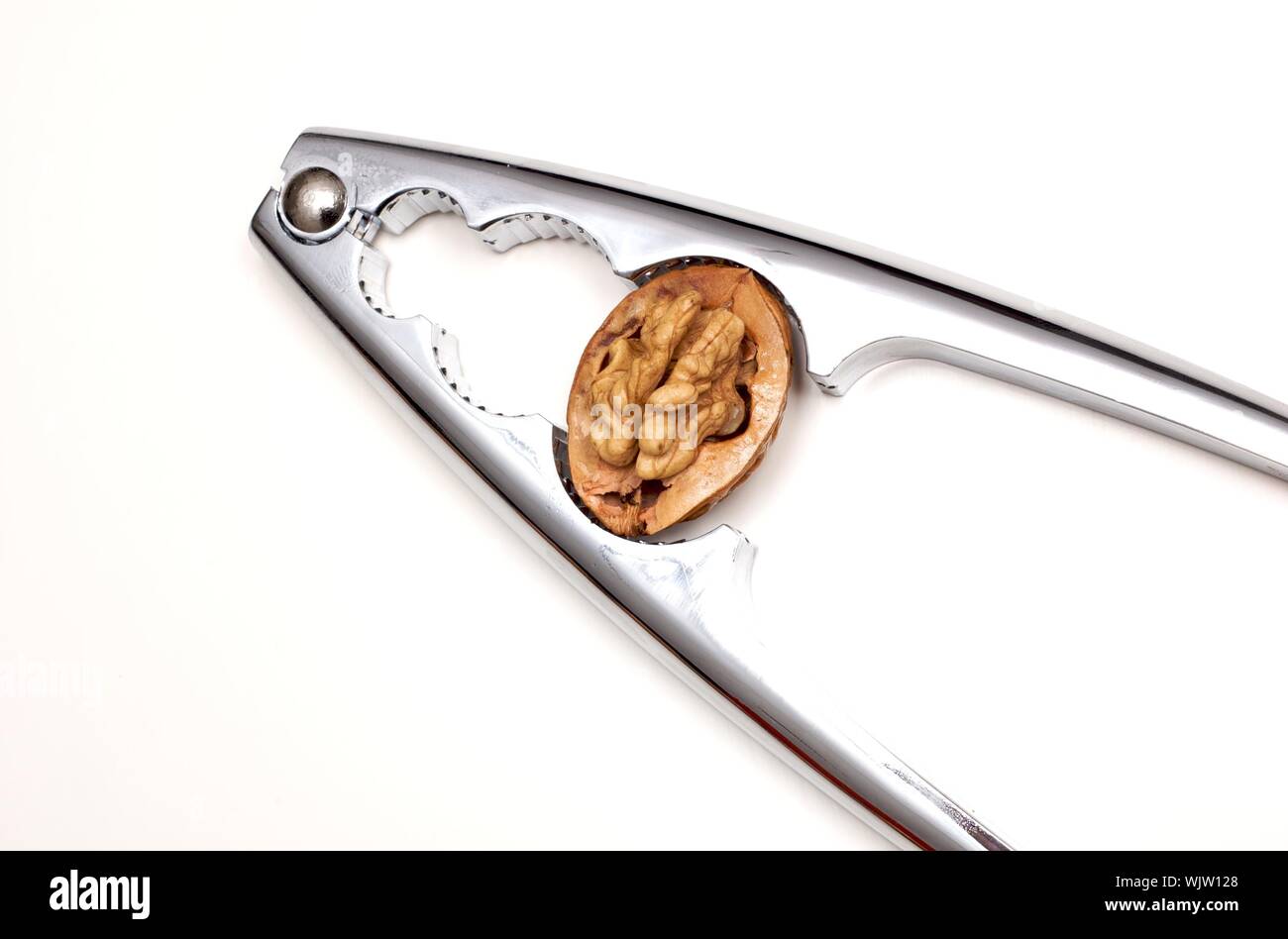 Modern steel nutcracker isolated on white Stock Photo - Alamy