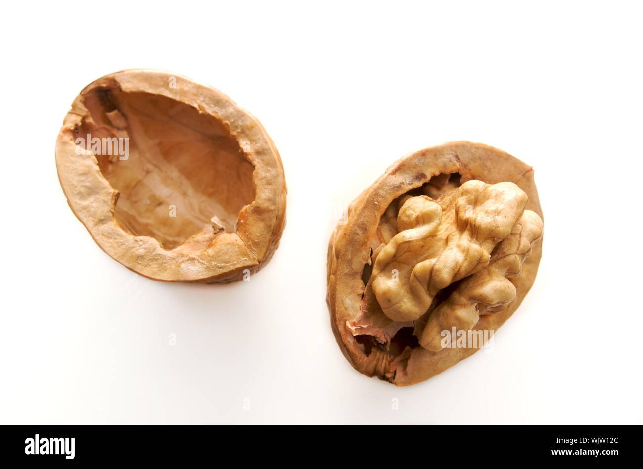 Open cracked walnut isolated on white Stock Photo - Alamy
