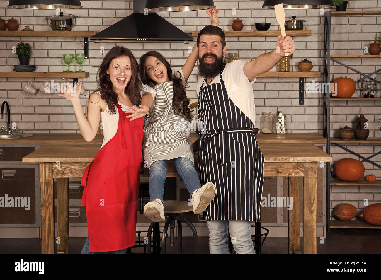 Cook it with care. Cook team while happy working. Little girl with ...