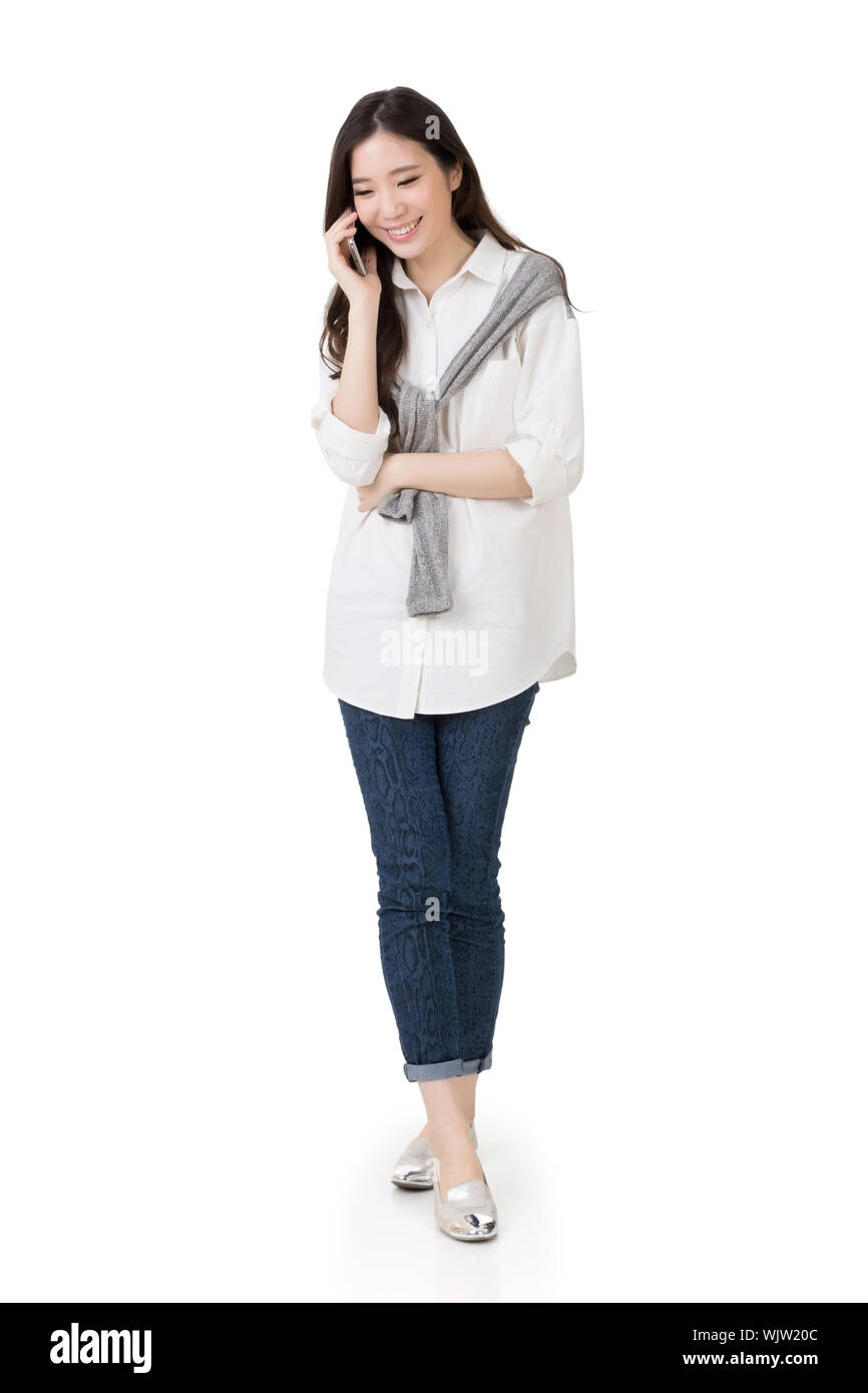 Woman talking with cellphone and smiling, full length portrait isolated ...