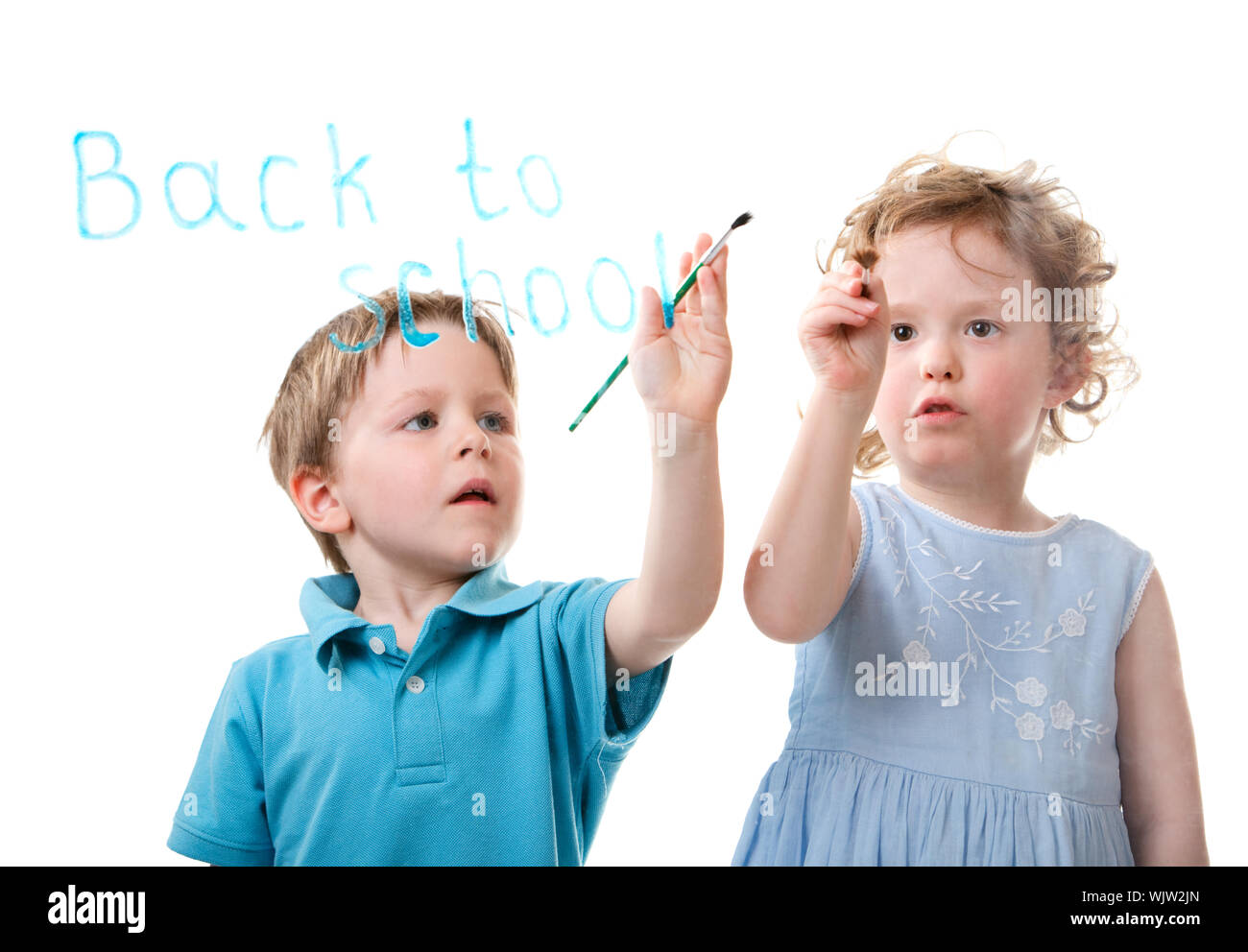 Little boy and girl writing Back to school on glass Stock Photo - Alamy