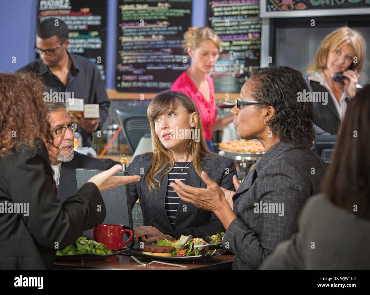 Mature diverse group of adults talking in indoor cafe Stock Photo - Alamy