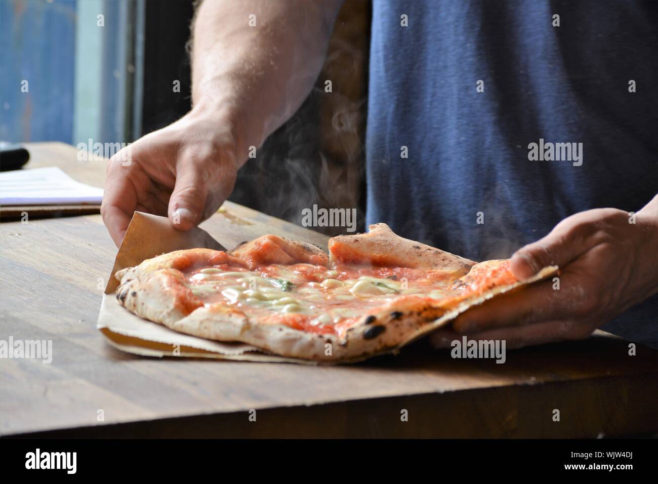 Man holding pizza hi-res stock photography and images - Alamy