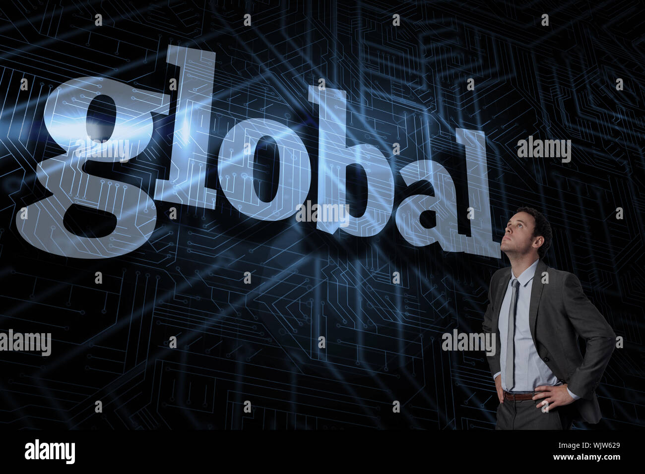The word global and serious businessman with hands on hips against ...