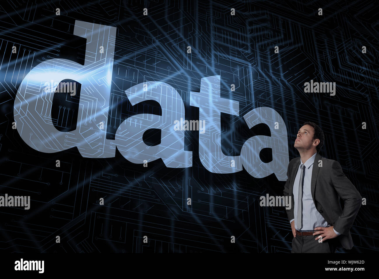 The word data and serious businessman with hands on hips against ...