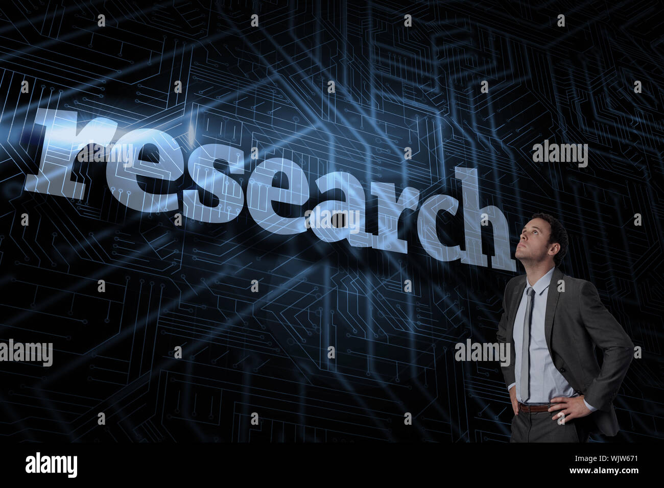 The word research and serious businessman with hands on hips against ...