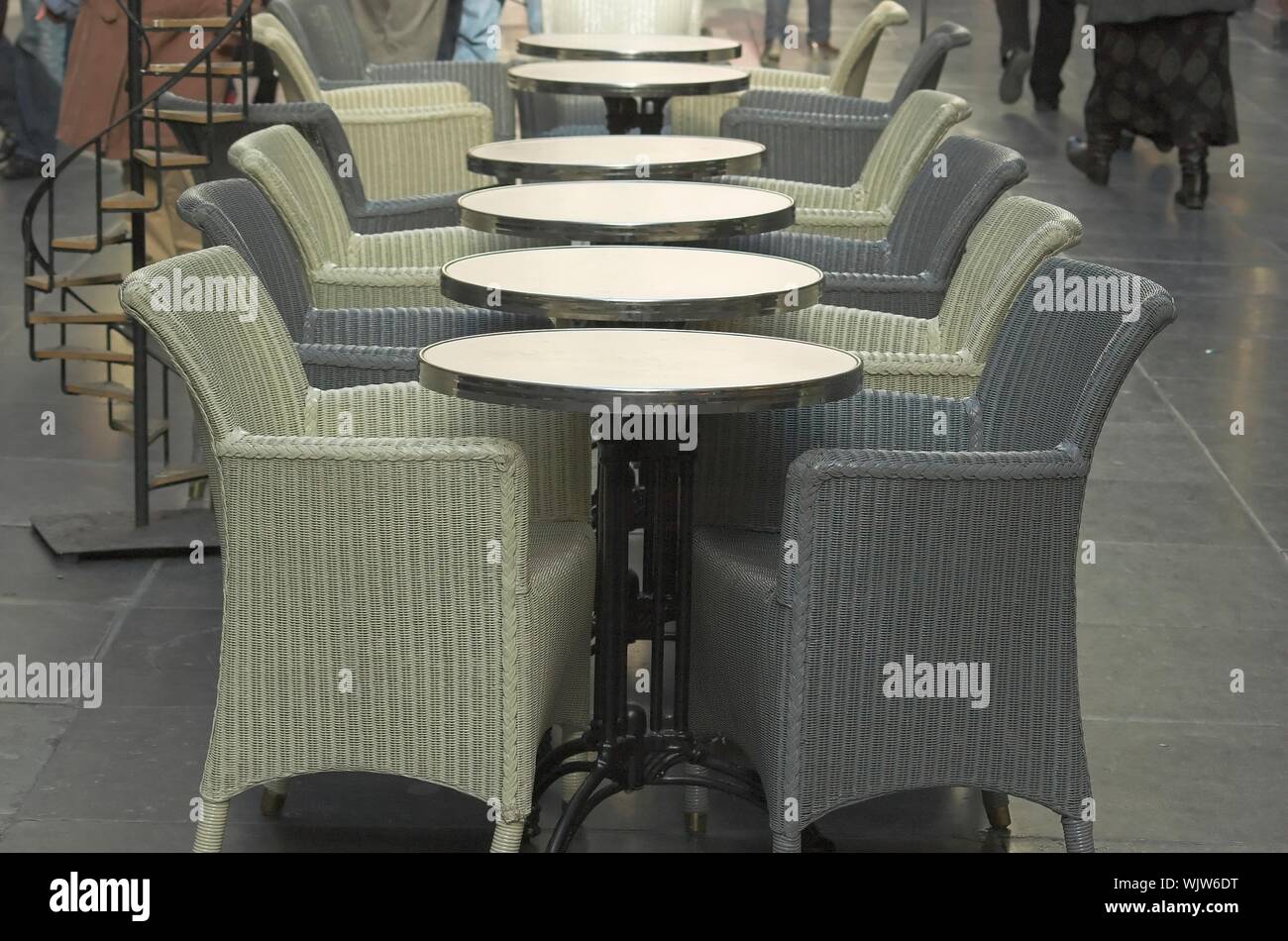 A row of coffee tables in a small cafe in the royal passage in Brussels ...