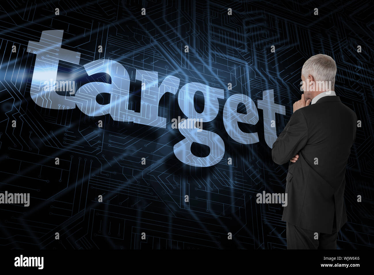 The word target and thoughtful businessman standing back to camera ...
