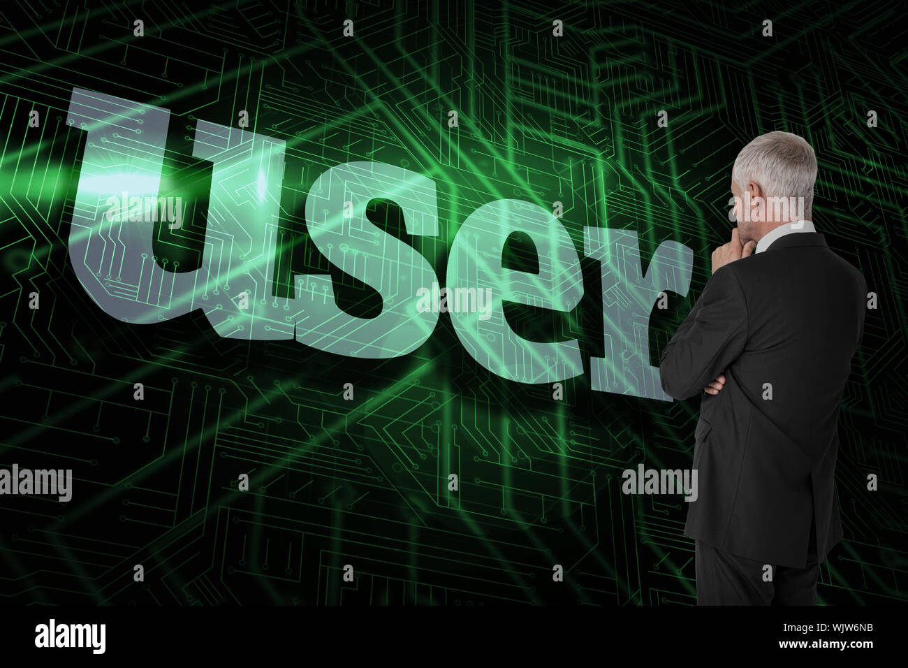 The word user and thoughtful businessman standing back to camera ...