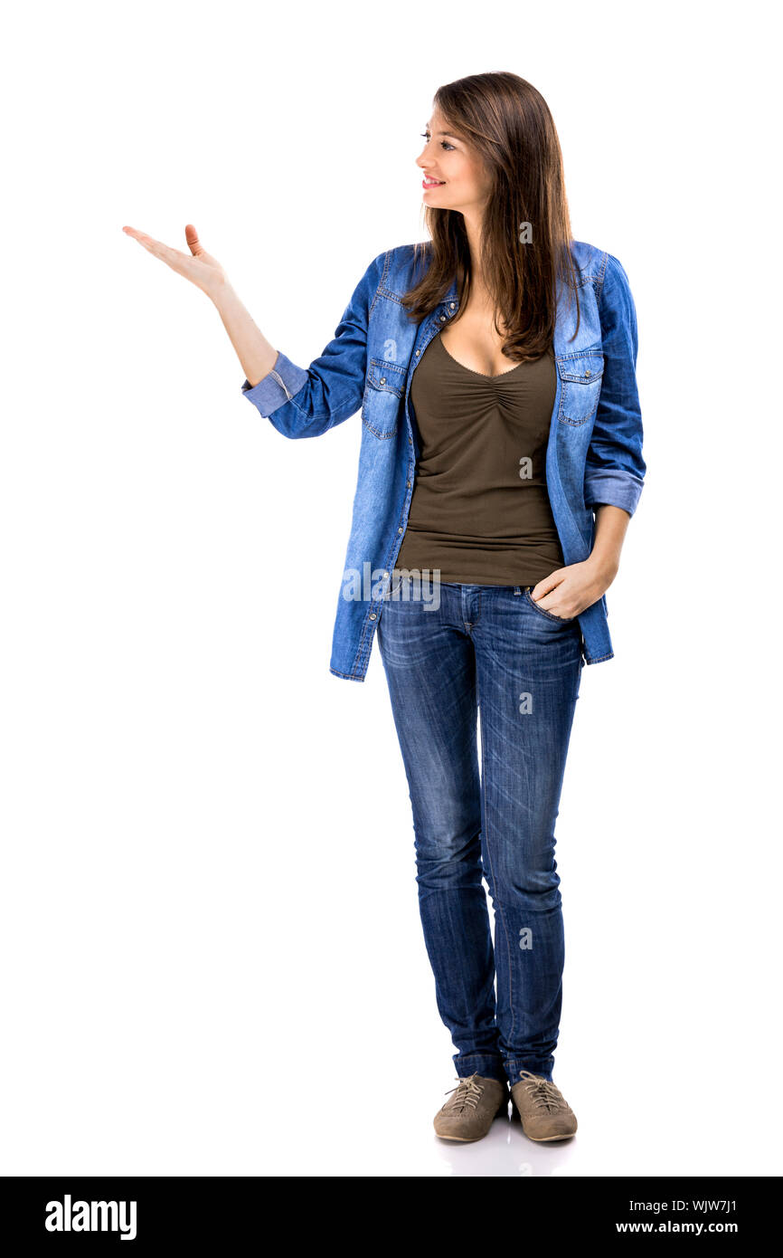 Beautiful woman standing over a white background and talking with ...