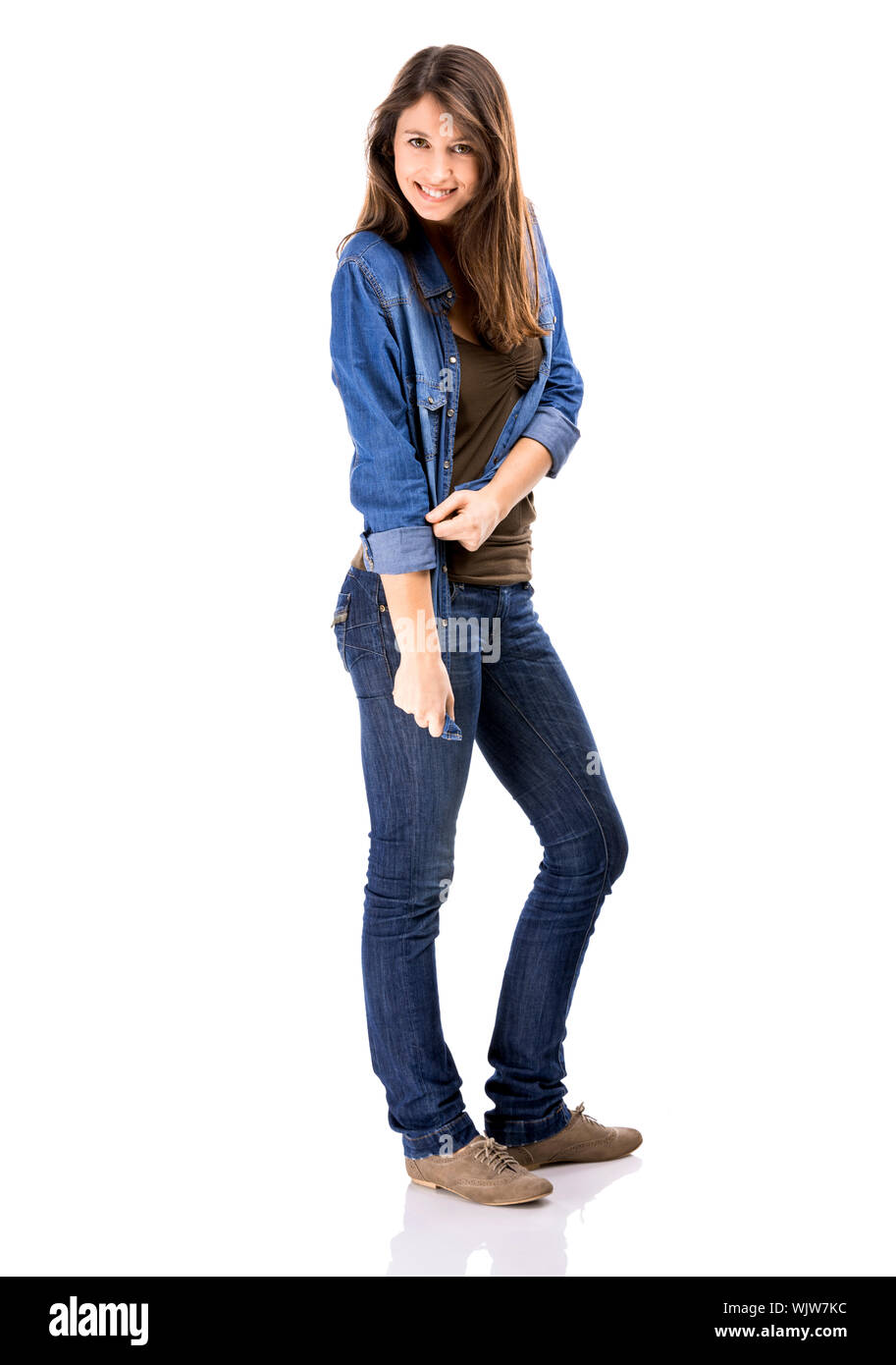 Beautiful young woman standing over a white background ans smiling ...