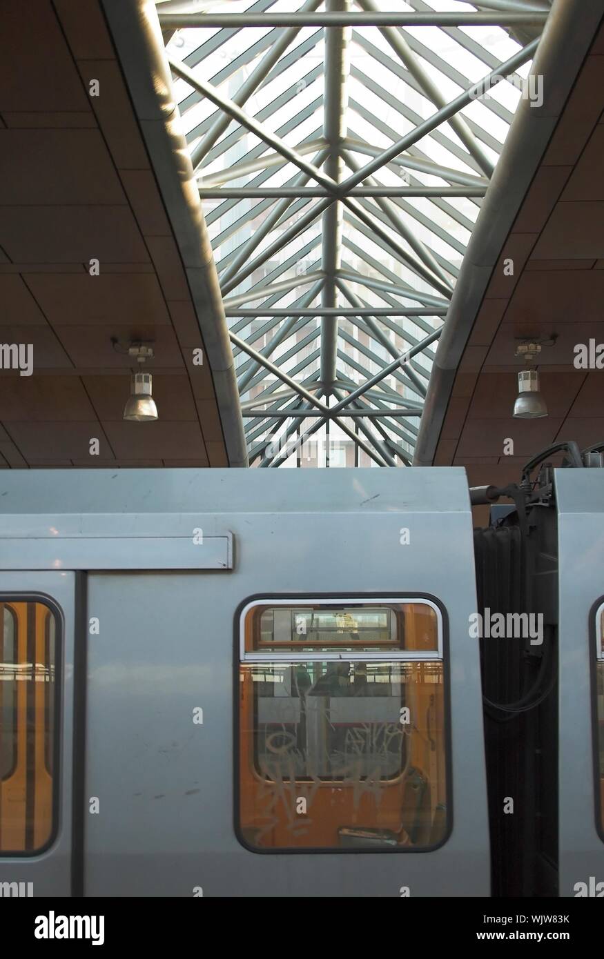 Detail of a metro train with a silhouette of a metro station roof Stock ...