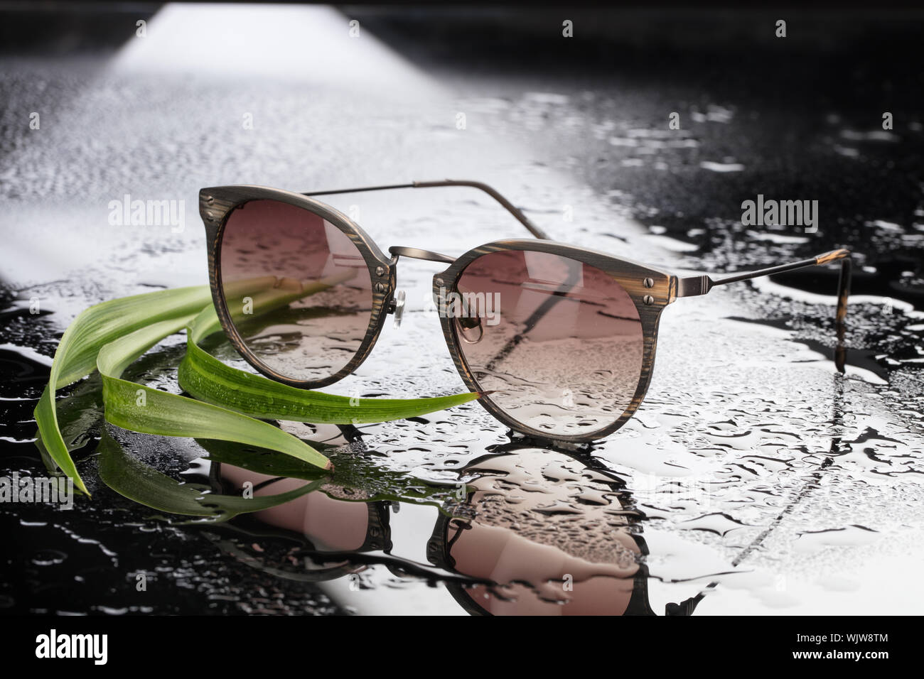 Sunglasses on a studio glass background Stock Photo - Alamy