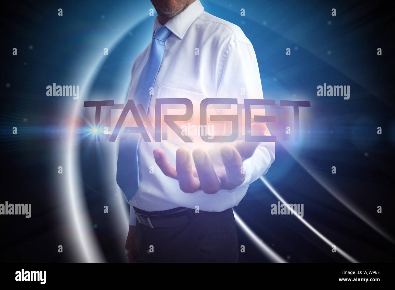 Businessman presenting the word target against black background with ...