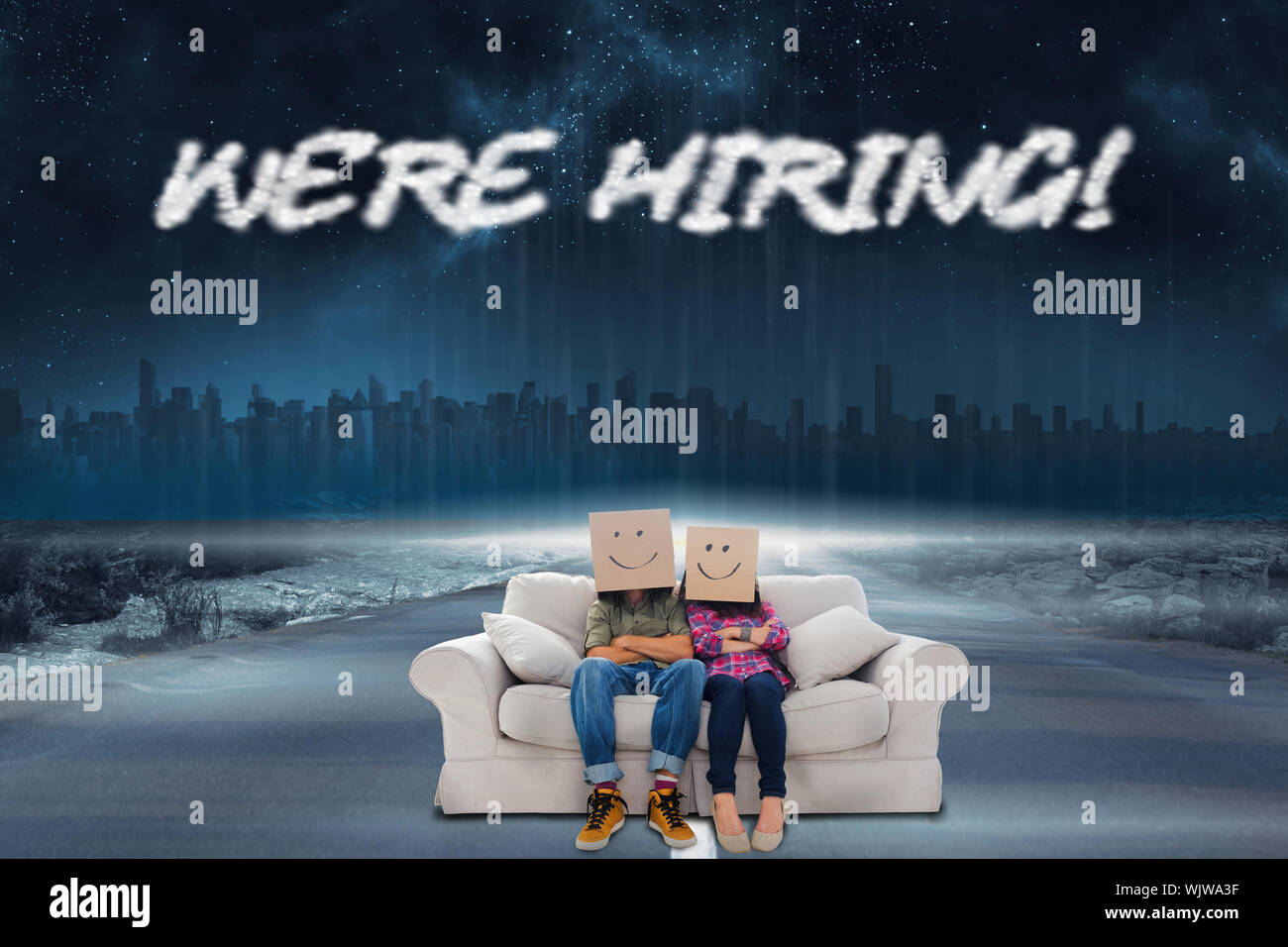 Silly employees with arms folded wearing boxes on their heads against ...