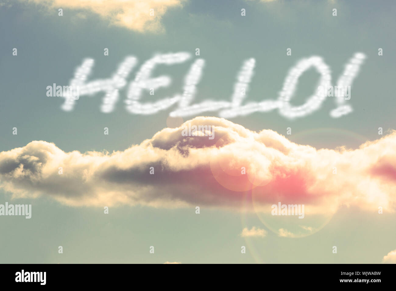 The word hello! against bright blue sky with cloud Stock Photo - Alamy