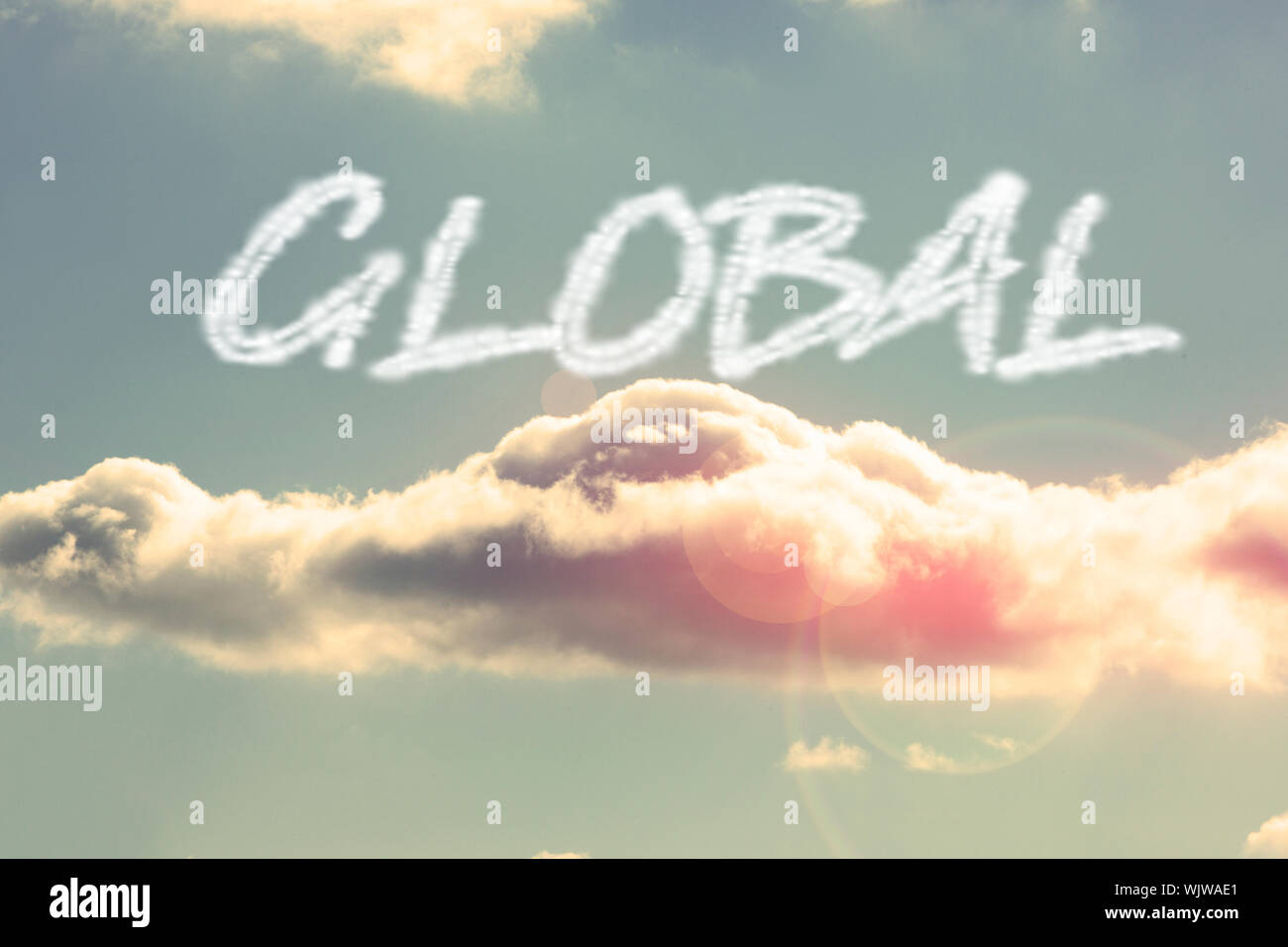 The word global against bright blue sky with cloud Stock Photo - Alamy