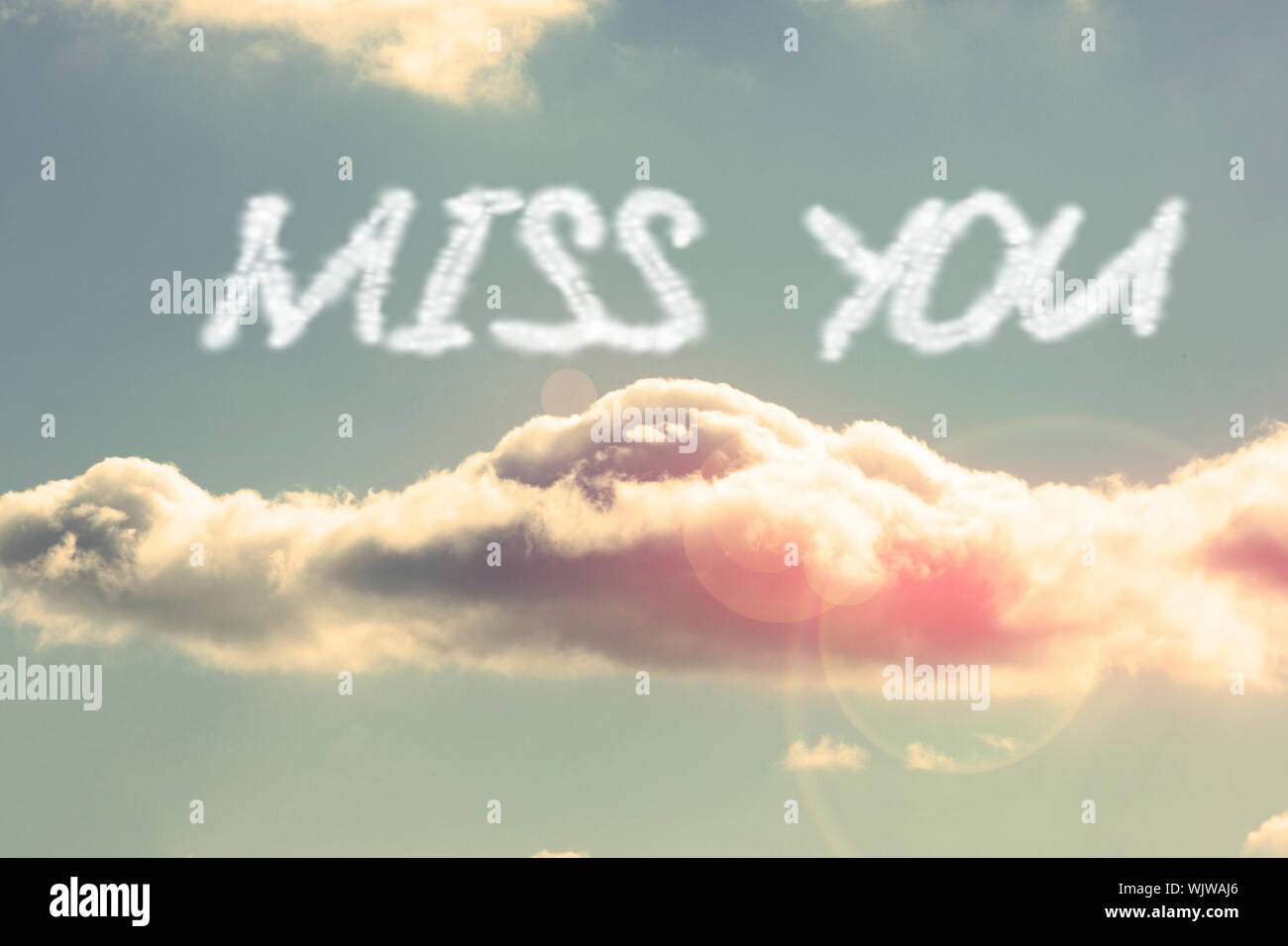 The word miss you against bright blue sky with cloud Stock Photo - Alamy