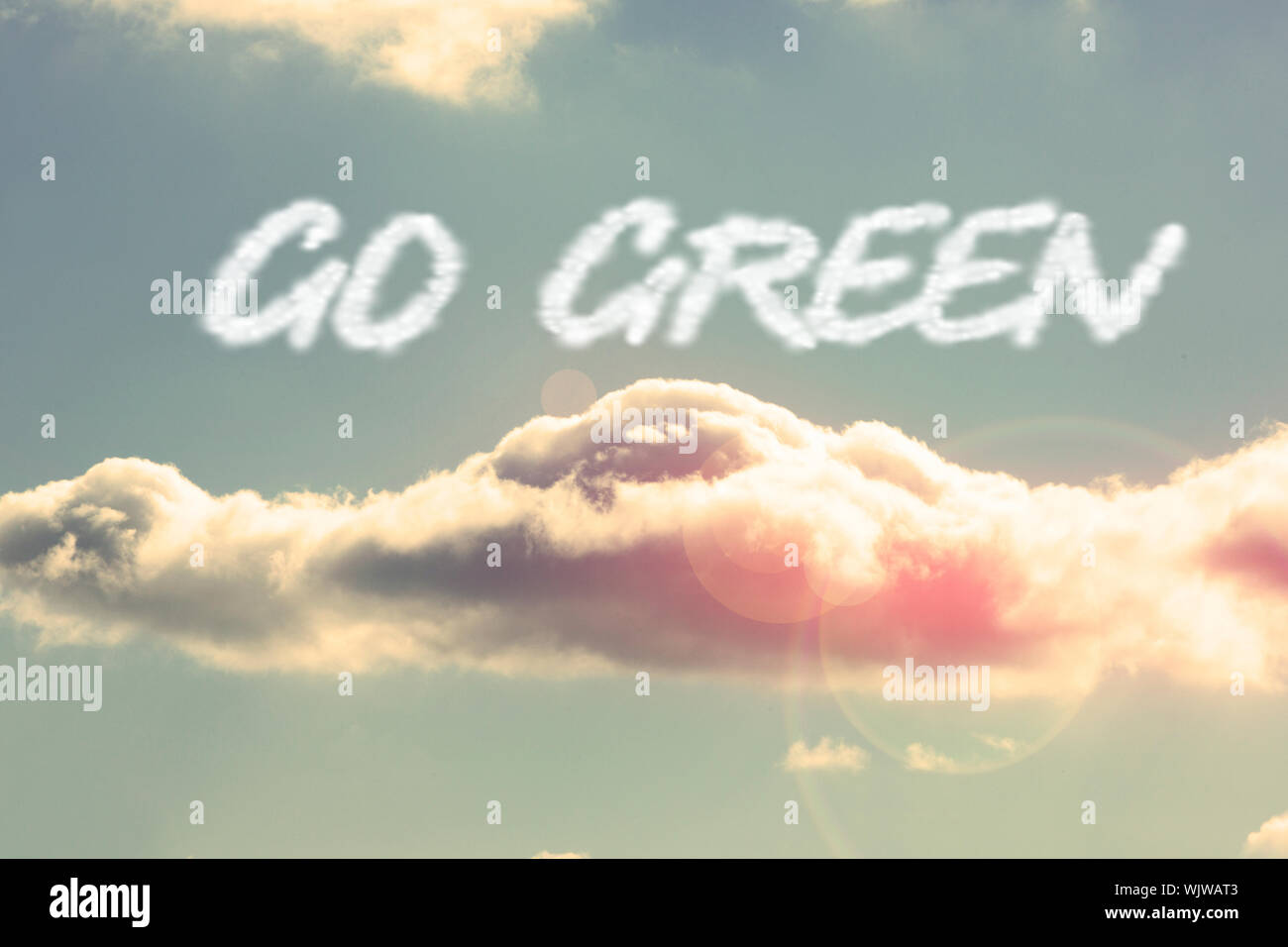 The word go green against bright blue sky with cloud Stock Photo - Alamy