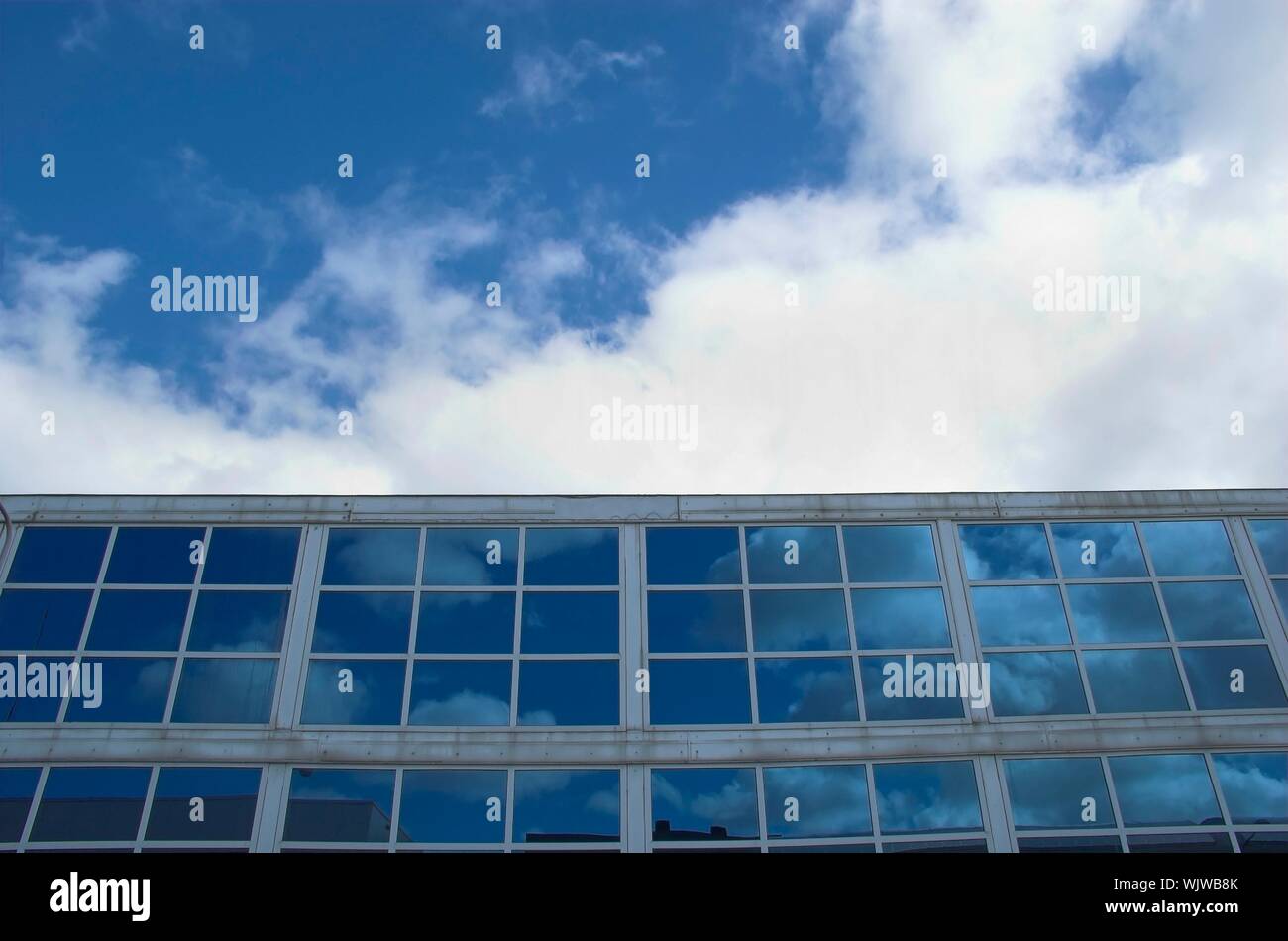 Detail of an office building facade with blue windows Stock Photo - Alamy
