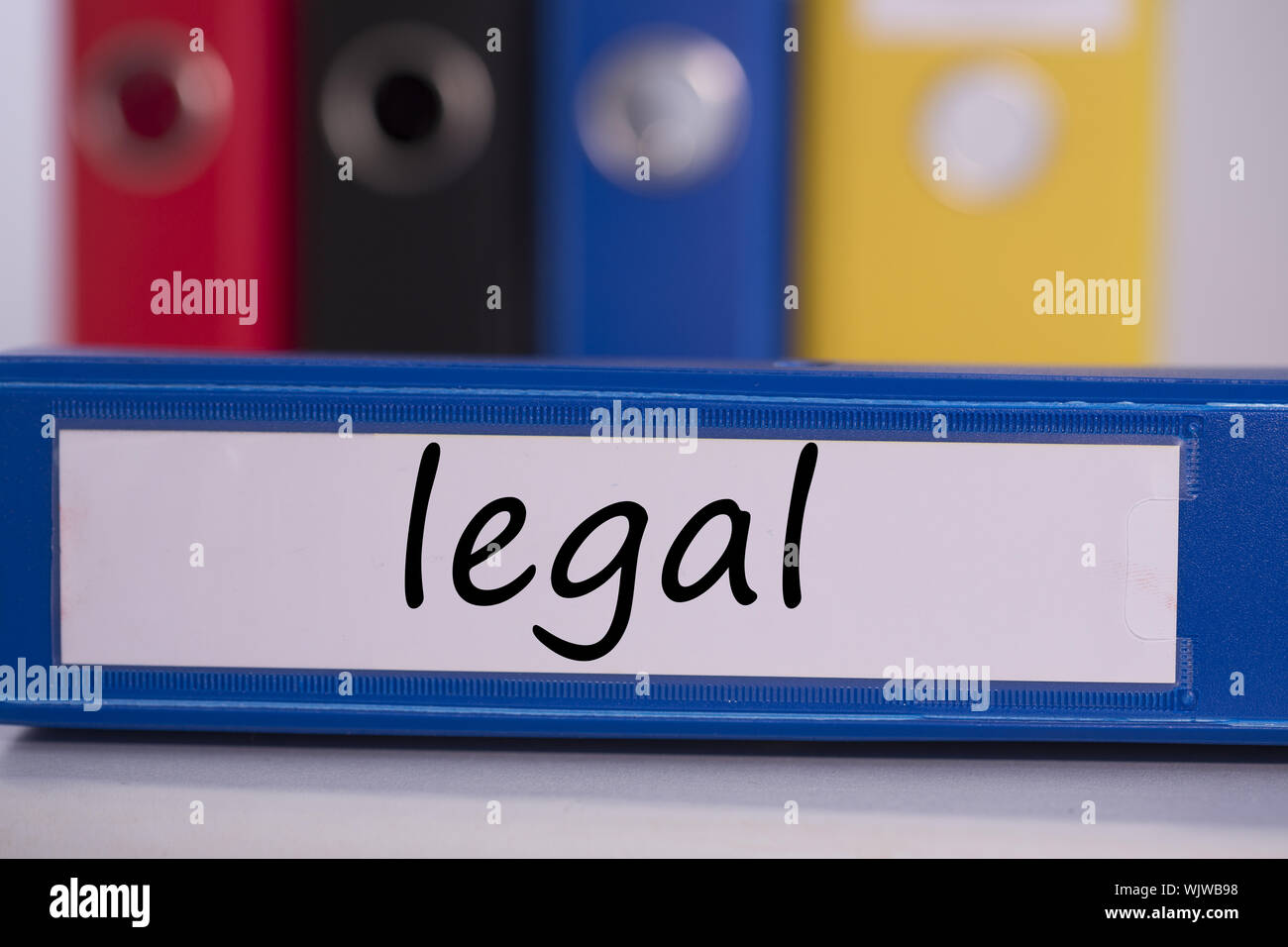 The word legal on blue business binder Stock Photo - Alamy