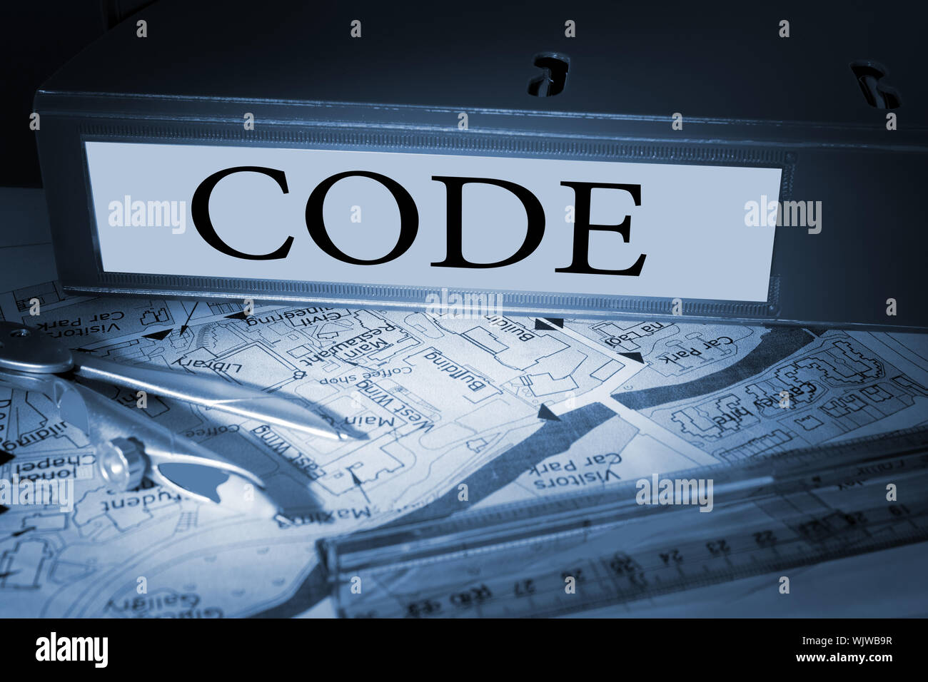 The word code on blue business binder on a desk Stock Photo - Alamy
