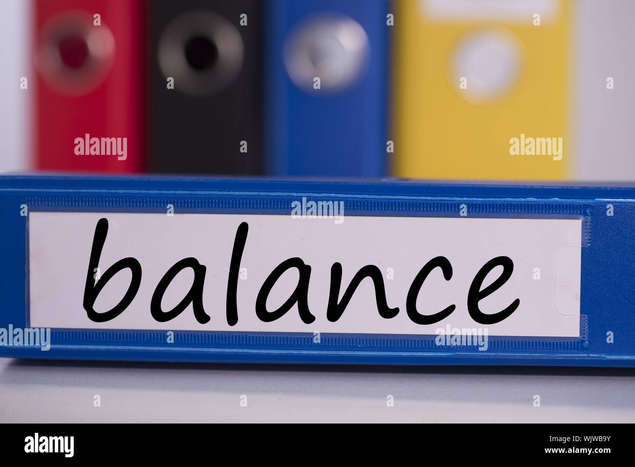 The word balance on blue business binder Stock Photo - Alamy