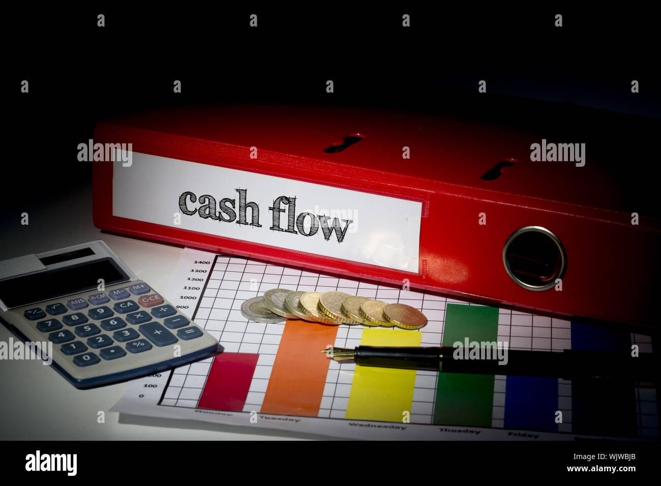 The word cash flow on red business binder on a desk Stock Photo - Alamy