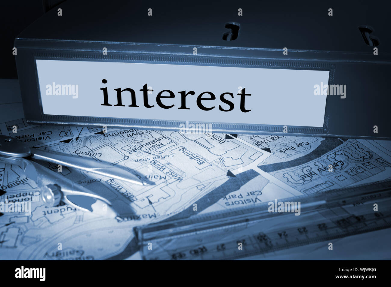 The word interest on blue business binder on a desk Stock Photo - Alamy