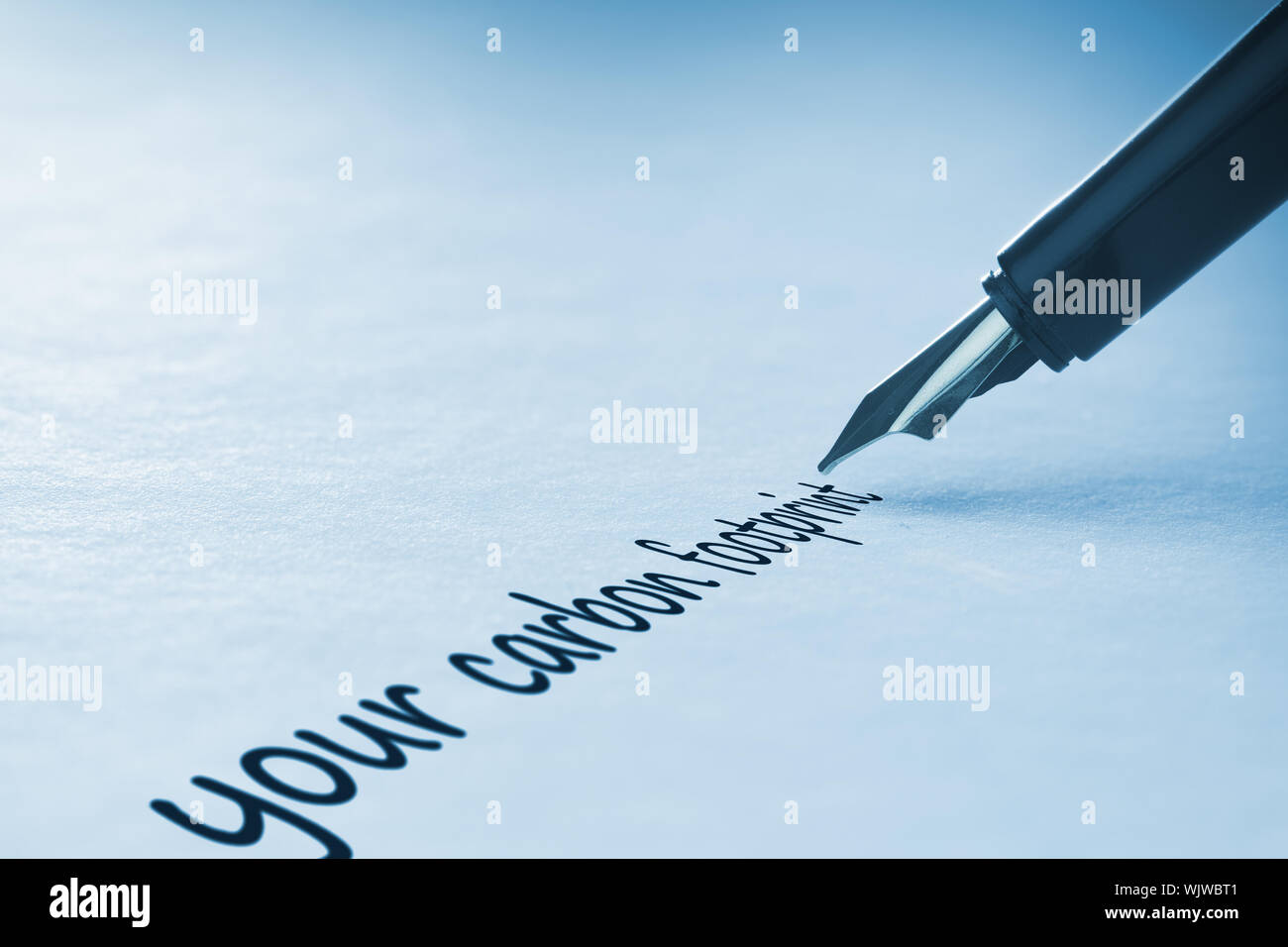 Fountain pen writing the word your carbon footprint Stock Photo - Alamy