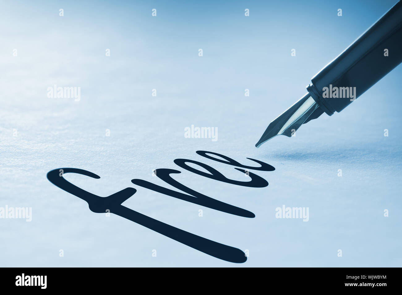 Fountain pen writing the word free Stock Photo - Alamy