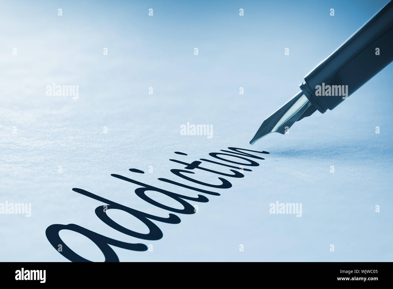 Fountain pen writing the word addiction Stock Photo - Alamy