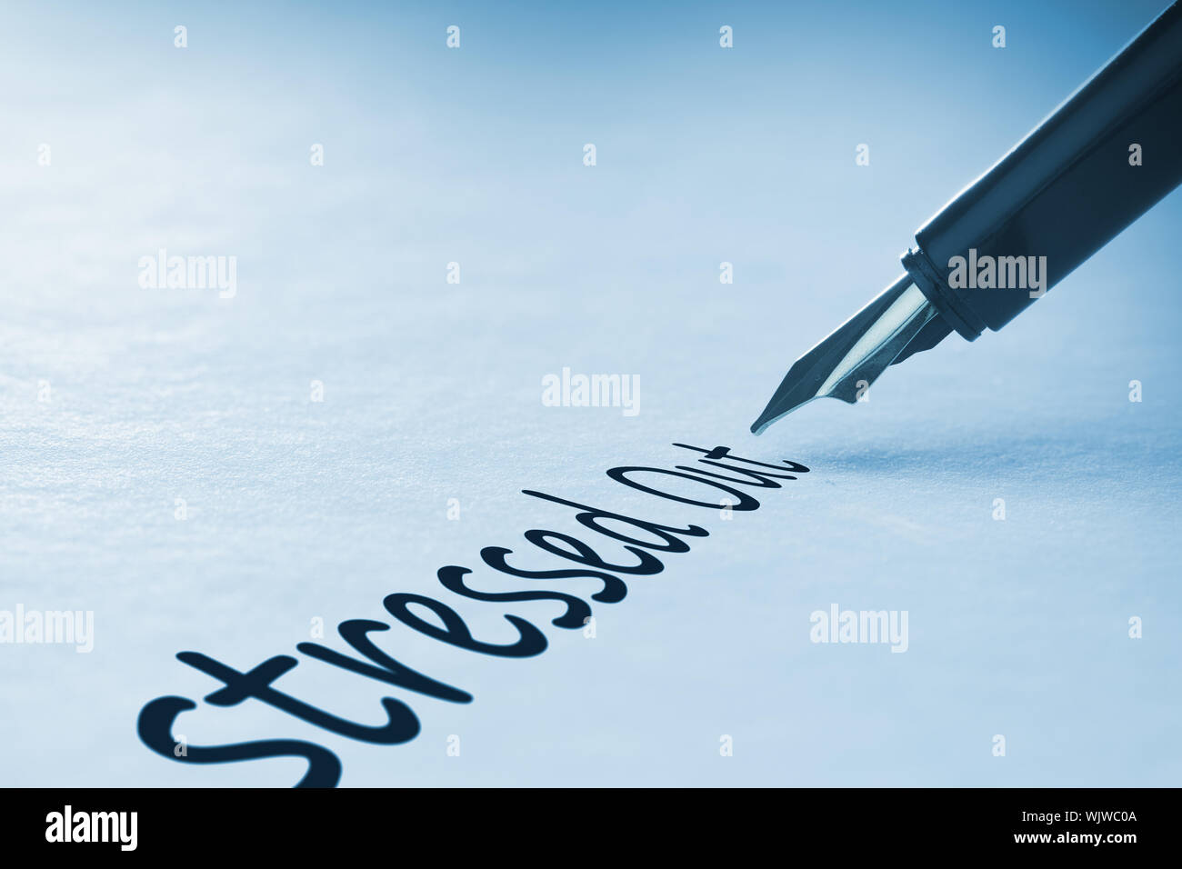 Fountain pen writing the word stressed out Stock Photo - Alamy