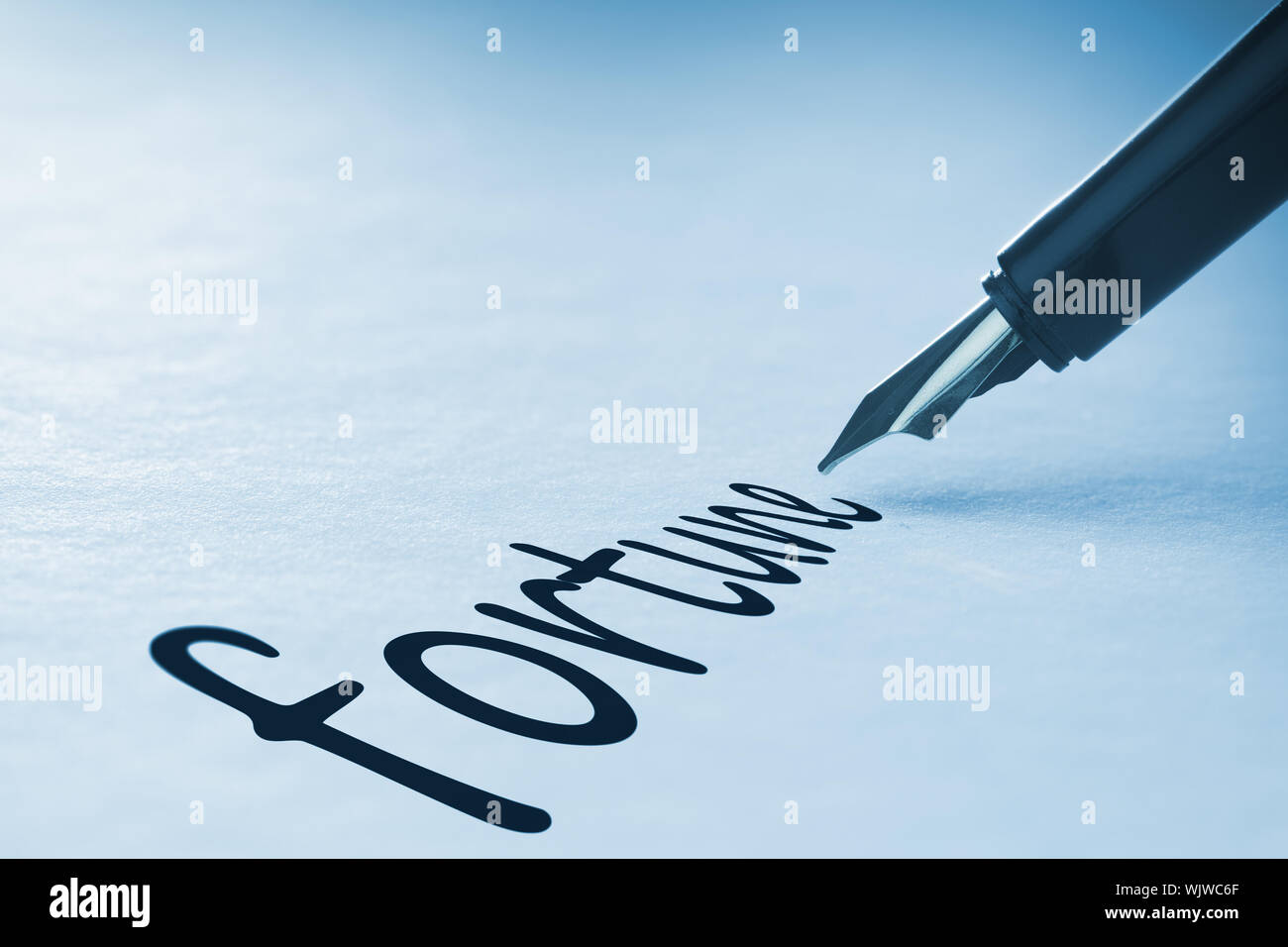 Fountain pen writing the word fortune Stock Photo - Alamy