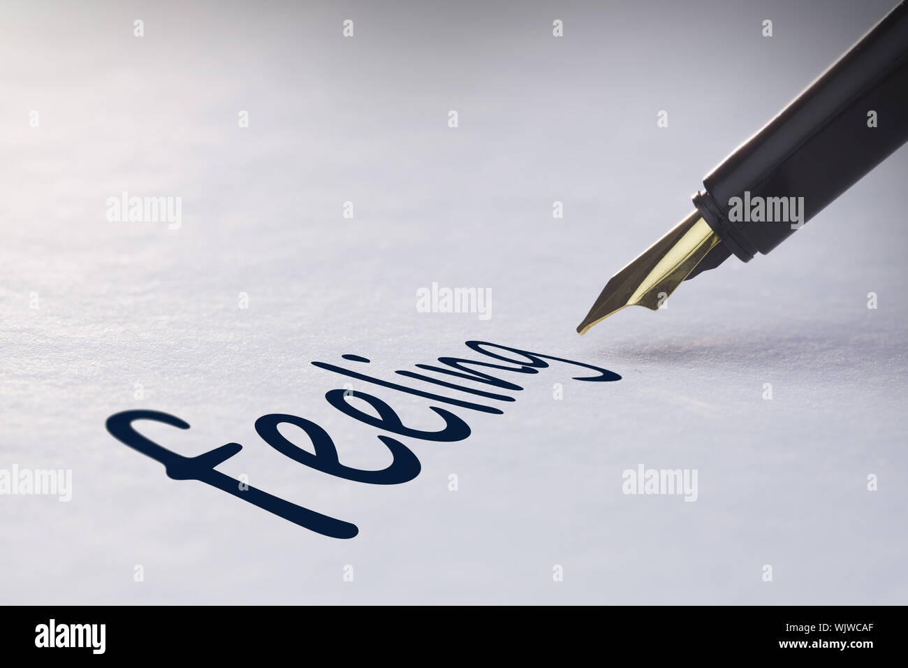 Fountain pen writing the word feeling Stock Photo - Alamy