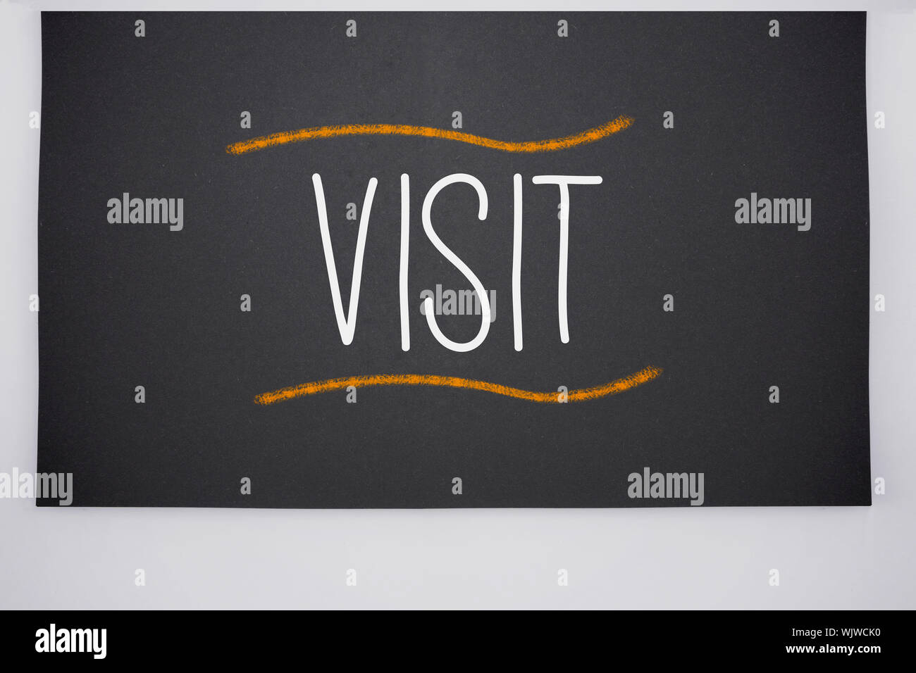 The word visit written on big blackboard Stock Photo - Alamy