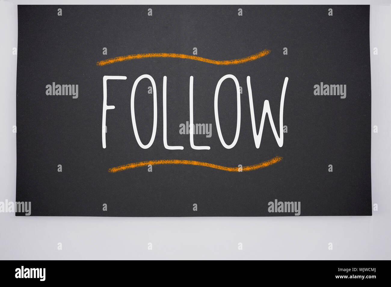 The word follow written on big blackboard Stock Photo - Alamy