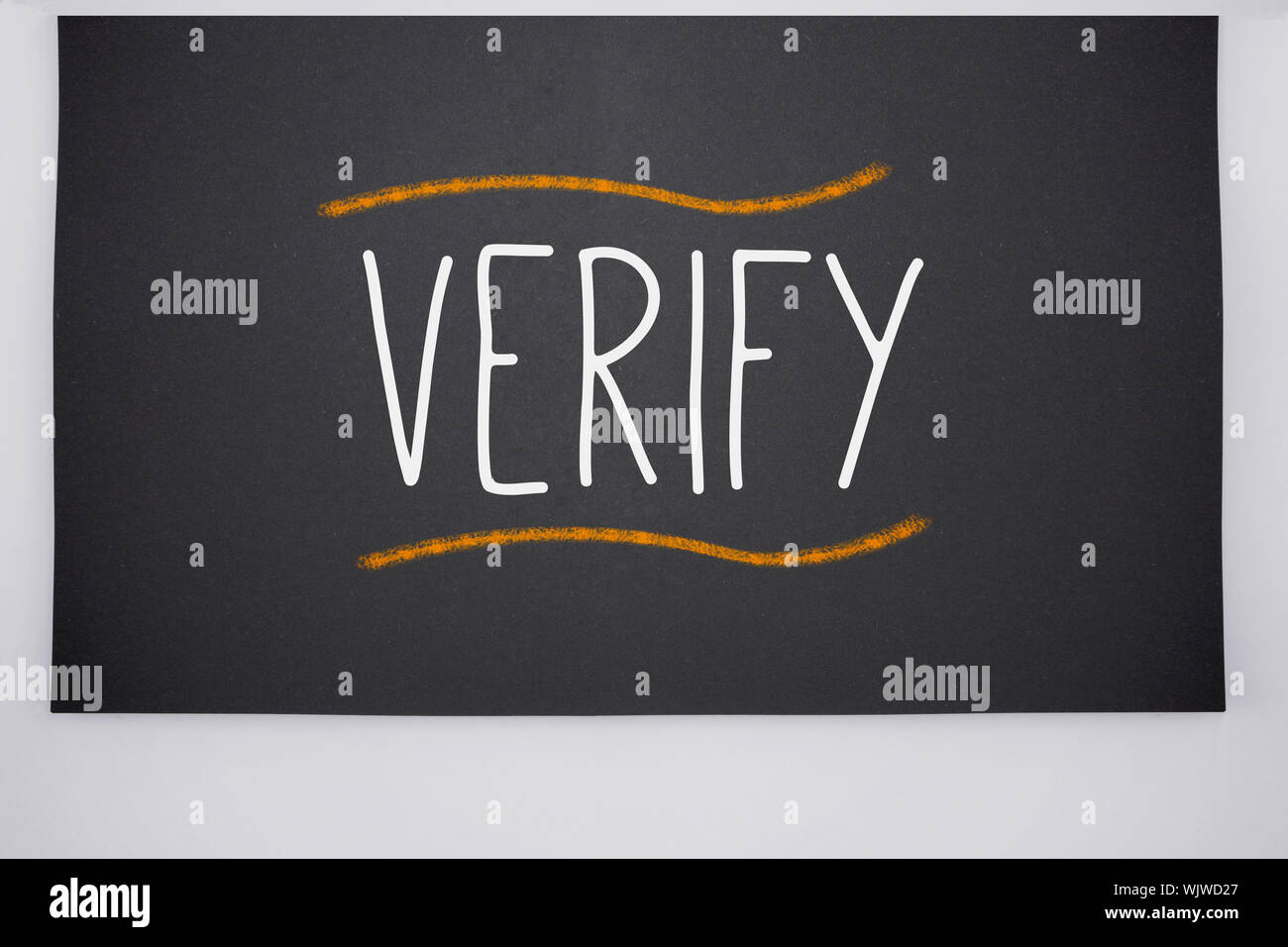 The word verify written on big blackboard Stock Photo - Alamy