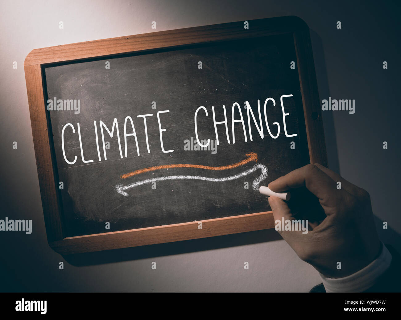 Hand writing the word climate change on black chalkboard Stock Photo ...