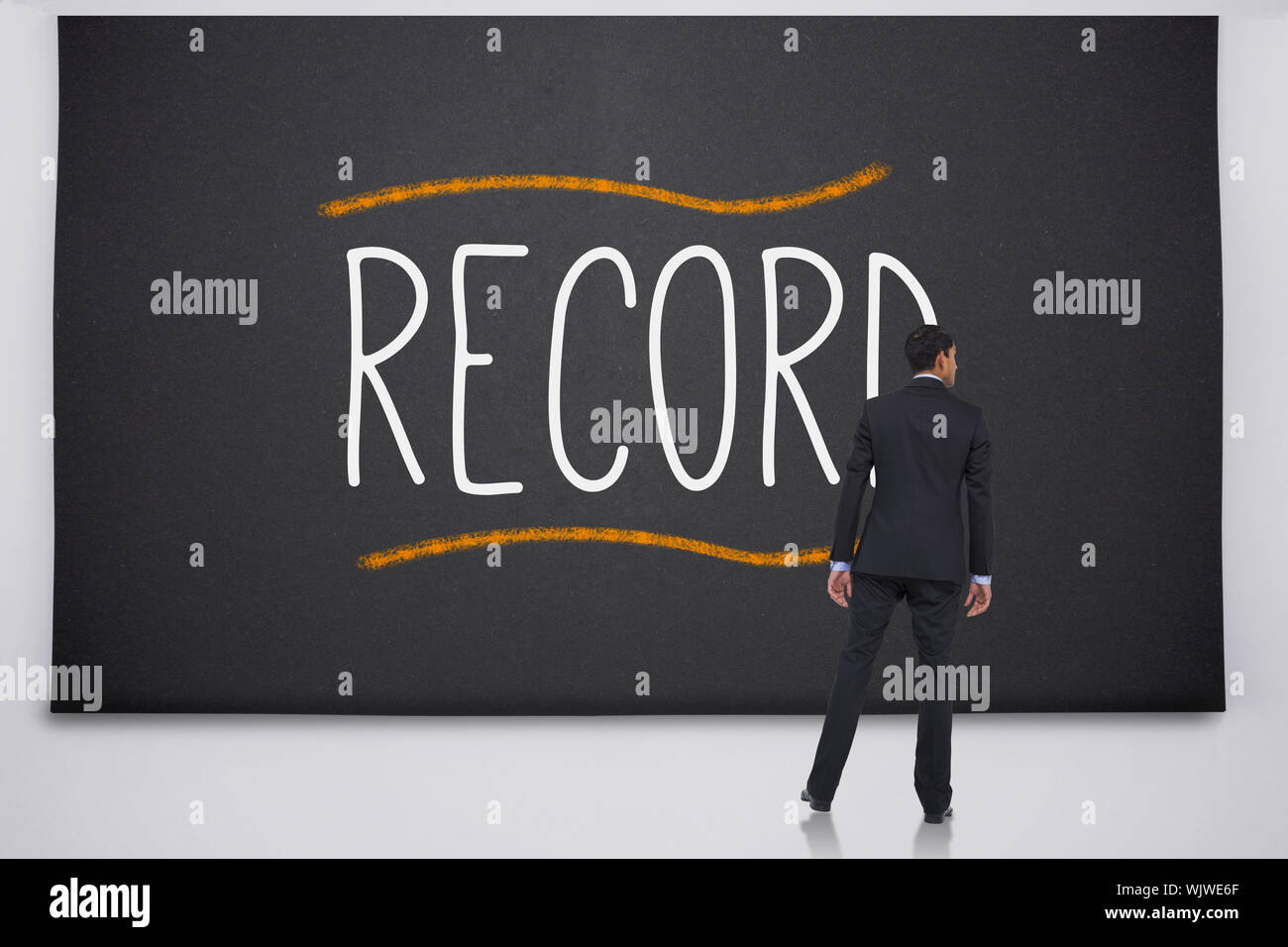 Businessman reading the word record Stock Photo - Alamy